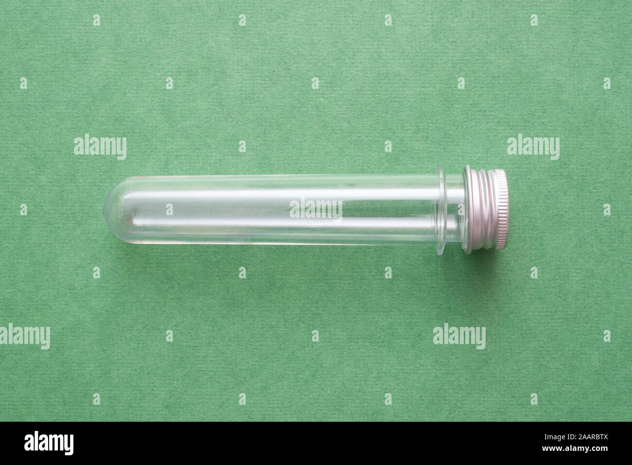 Empty test tube on green background Stock Photo - Alamy