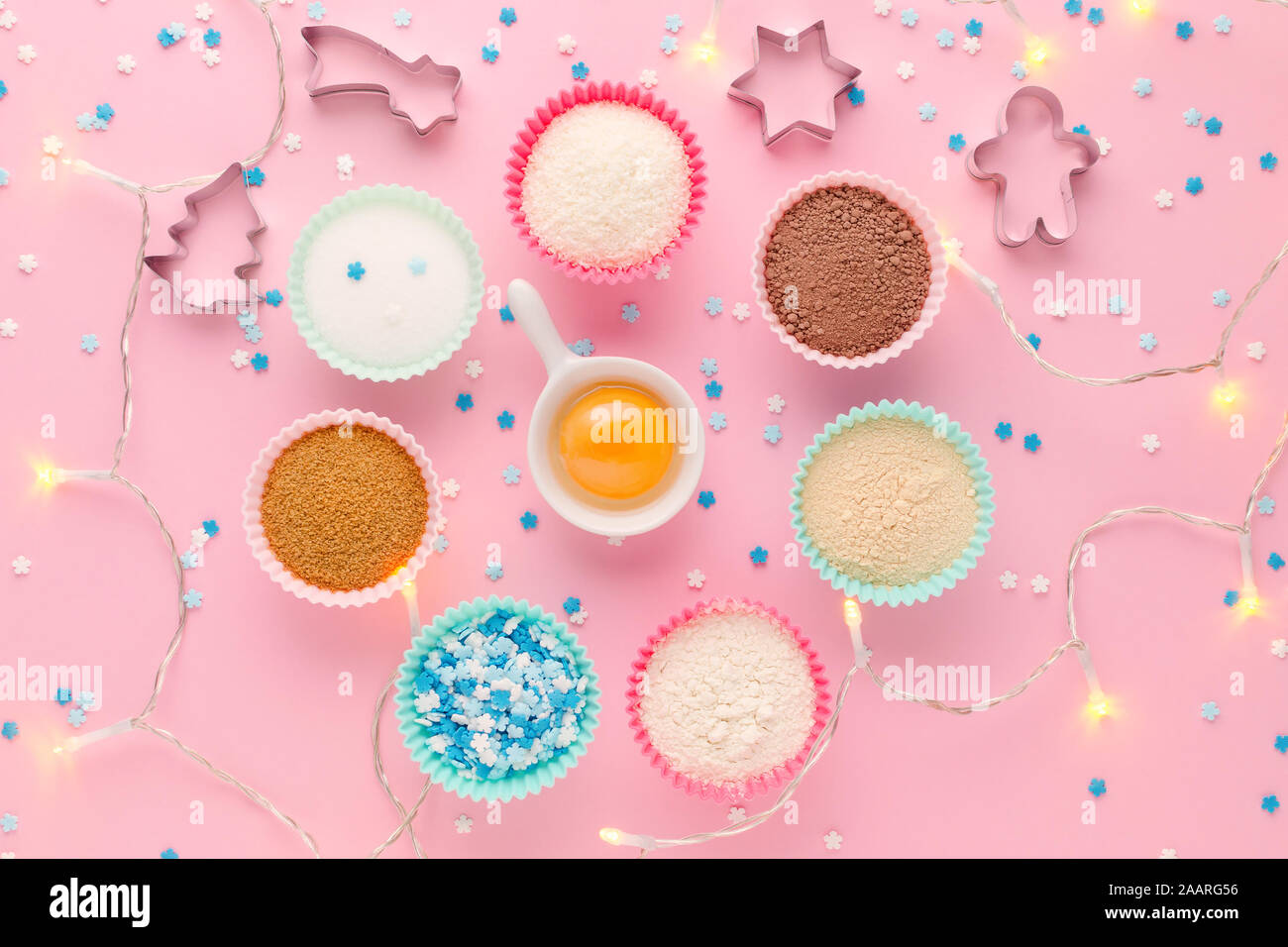 ingredients like a clock, baking time concept, on pink background with ...