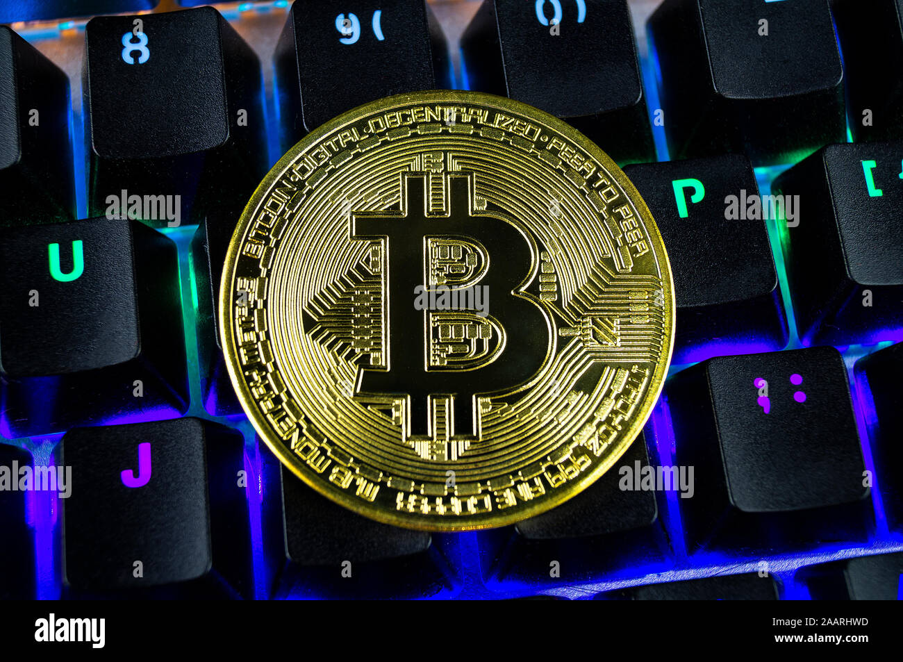 Coin cryptocurrency bitcoin close-up of the colour-coded keyboard ...