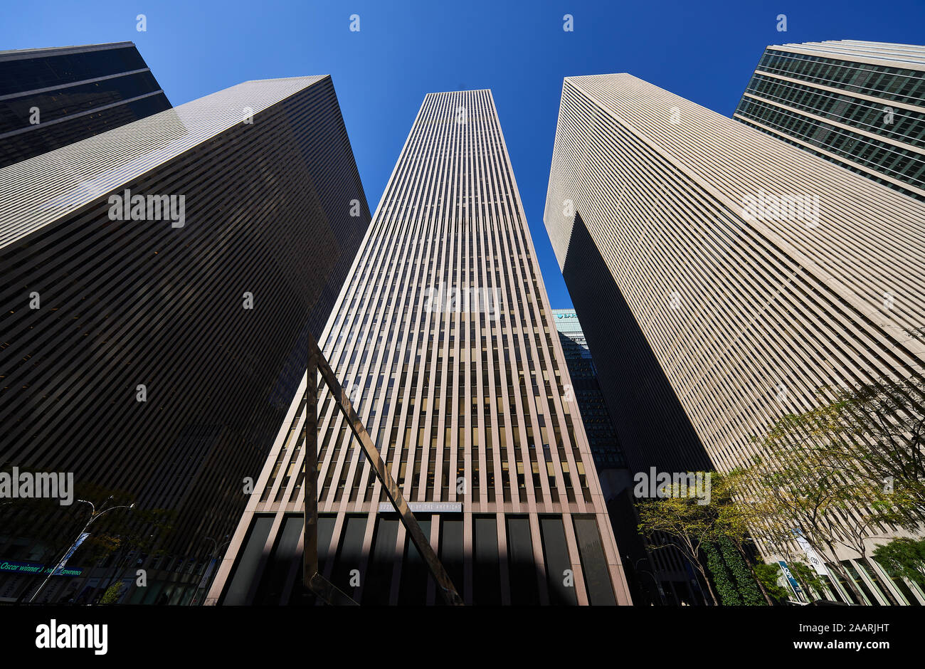 view of the massive midtown buildings in Manhattan from street level ...