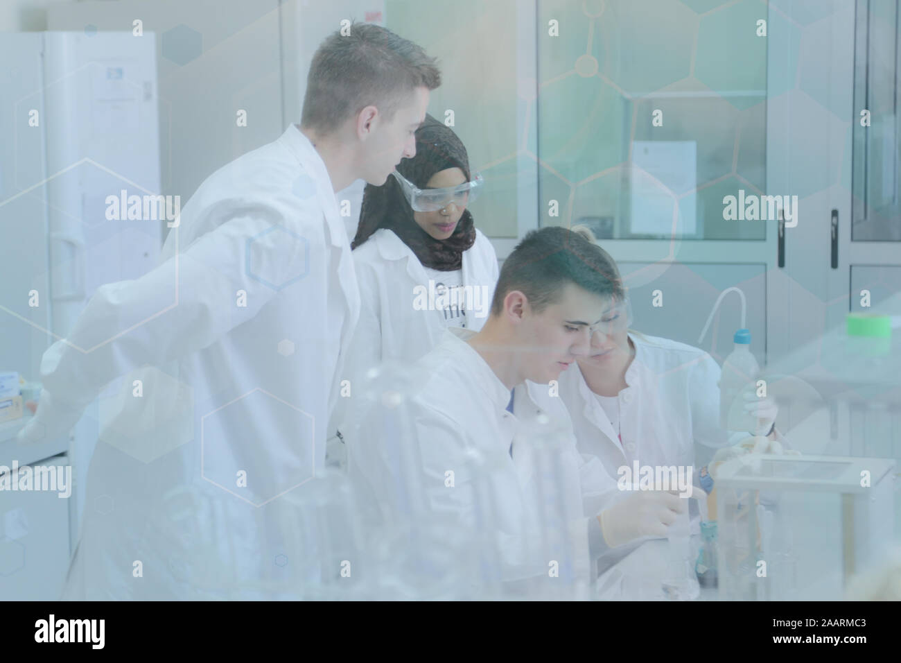 Group of young scientists doing experiments in laboratory Stock Photo ...