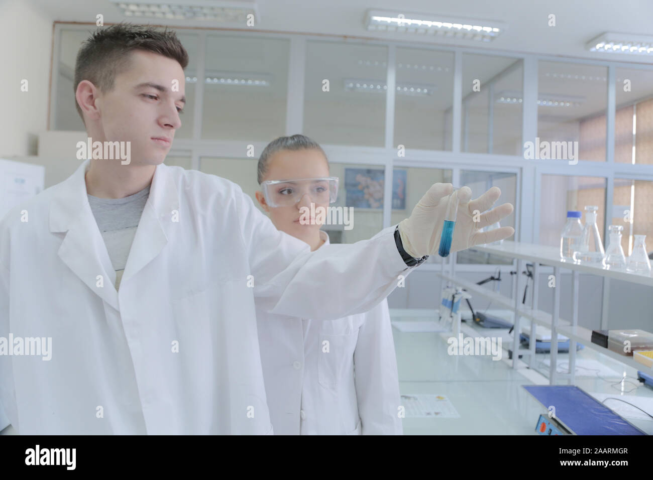 Two young students scientists doing experiments in laboratory Stock ...