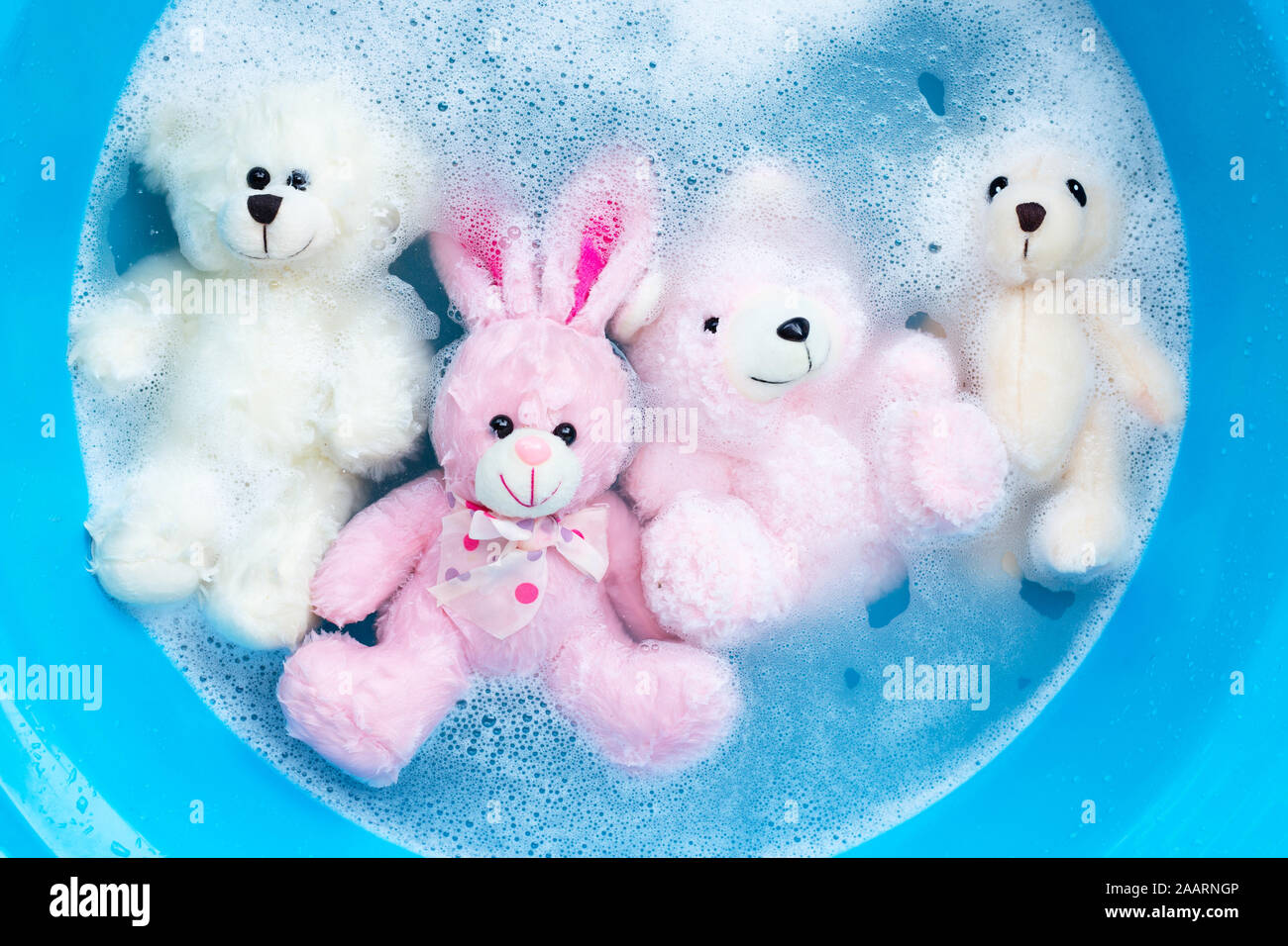 Soak rabbit doll with toy bears in laundry detergent water dissolution ...