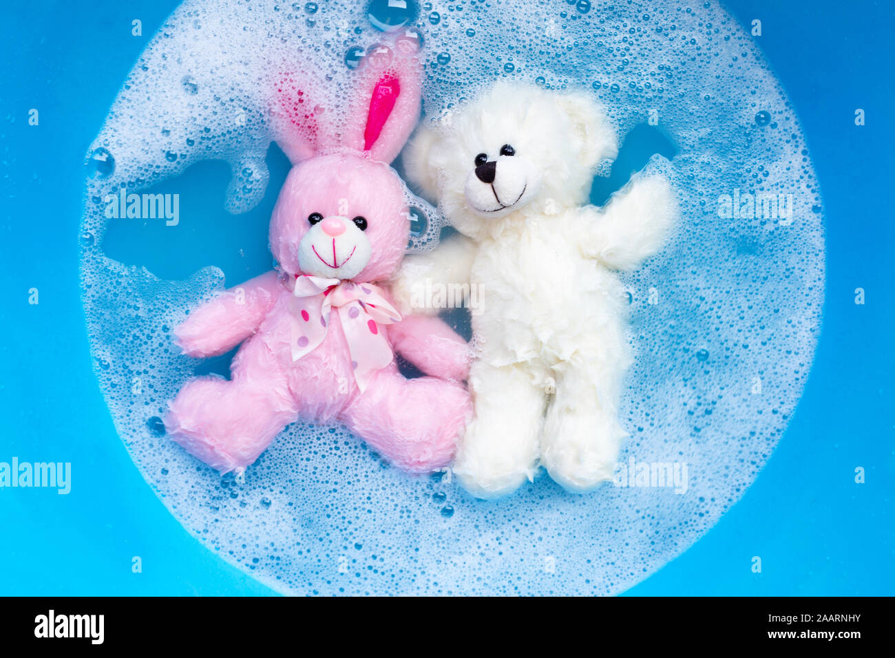 Soak rabbit doll with toy teddy bear in laundry detergent water ...