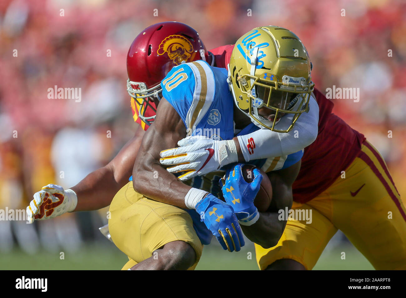 UCLA Bruins running back Demetric Felton (10) gets wrapped up by USC ...