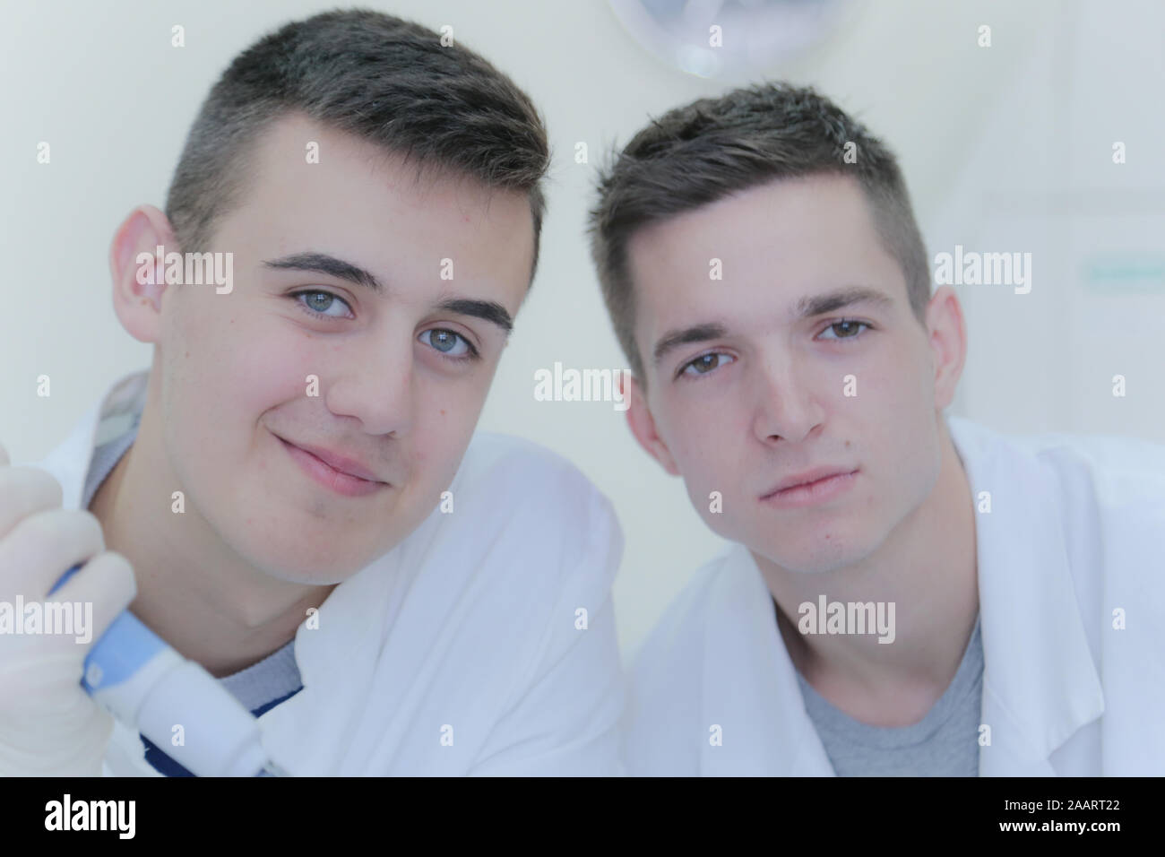 Two young male genetic scientists looking at camera and smilling Stock ...