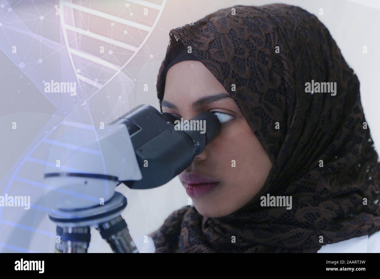 Young african muslim female scientist looking through a microscope in a ...