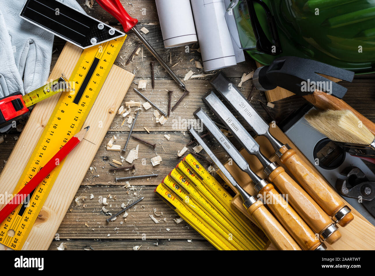 View from above of carpenter's tools on an antique wooden table ...