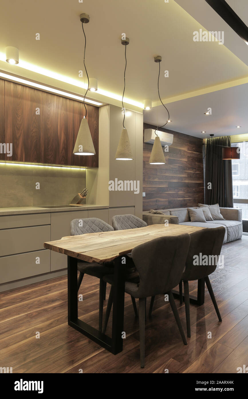 Wooden dining table in a modern kitchen interior Stock Photo - Alamy