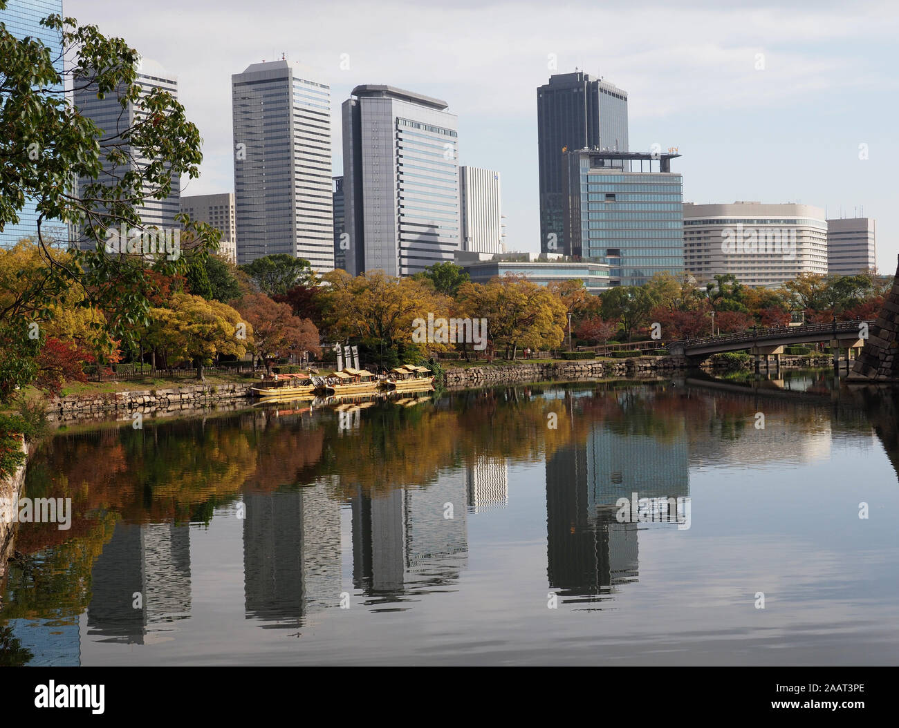 A view of the Osaka skyline and fall foliage as seen from Osaka Castle ...