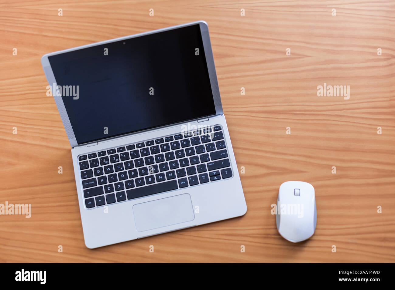 Modern laptop with white mouse over wood table Stock Photo - Alamy