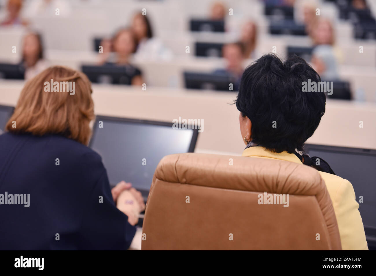 Business woman as leader speaking at Conference. Audience at the ...