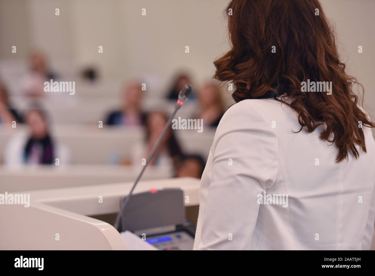 Business woman as leader speaking at Conference. Audience at the ...
