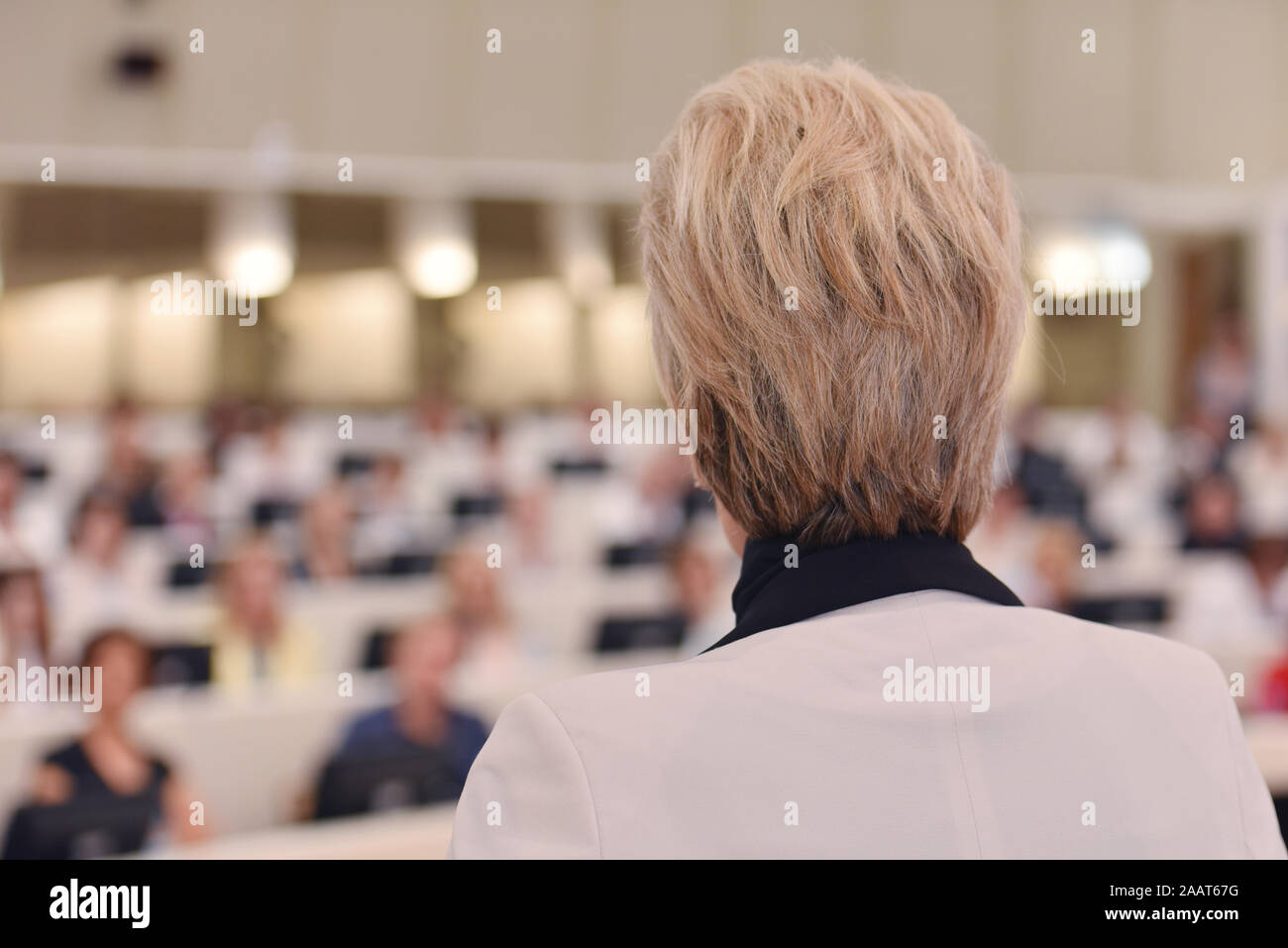 Business woman as leader speaking at Conference. Audience at the ...