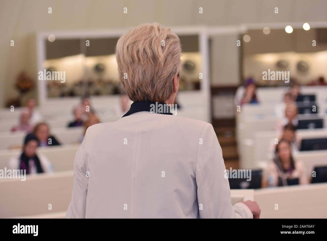Business woman as leader speaking at Conference. Audience at the ...