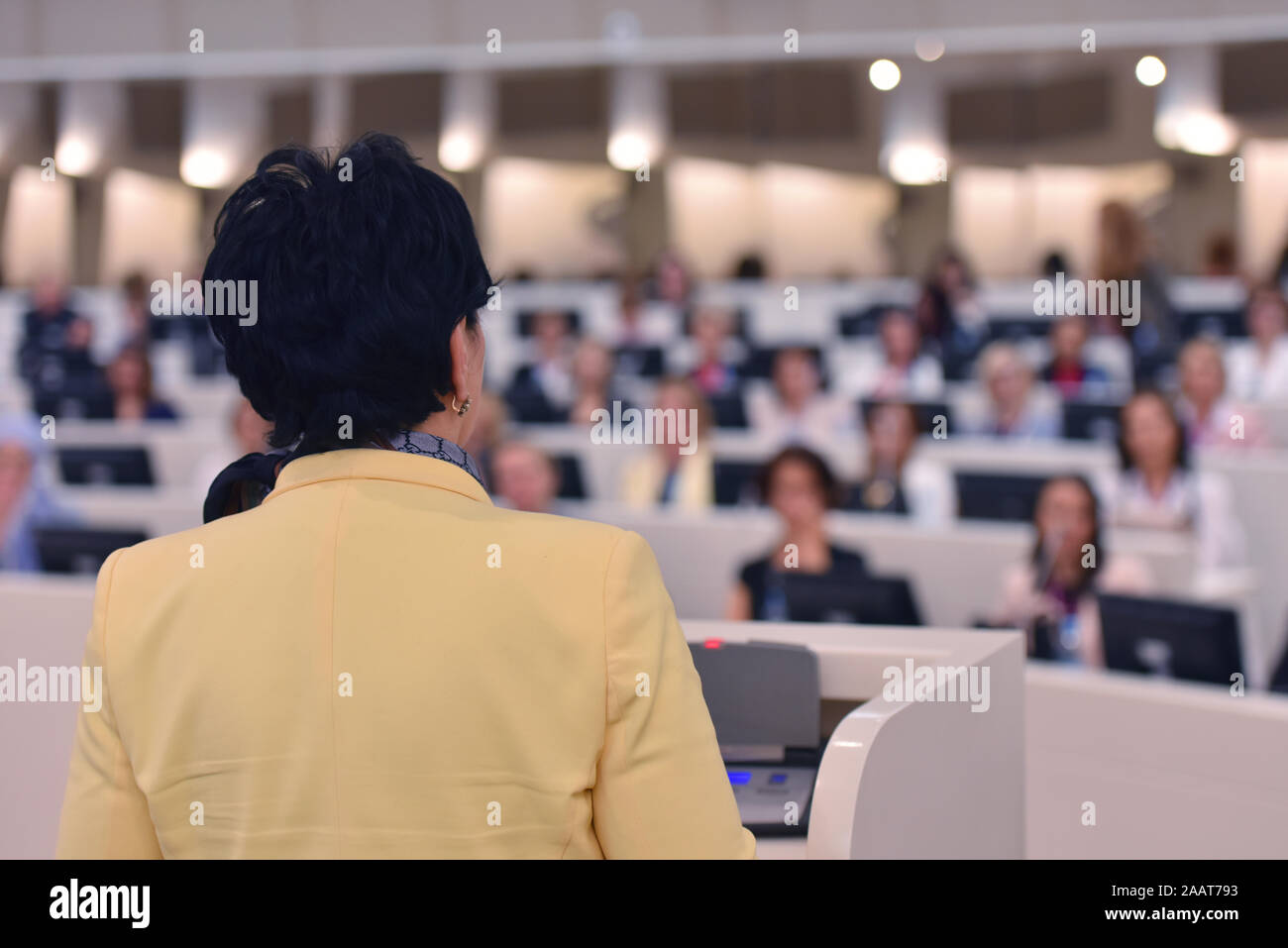 Business woman as leader speaking at Conference. Audience at the ...