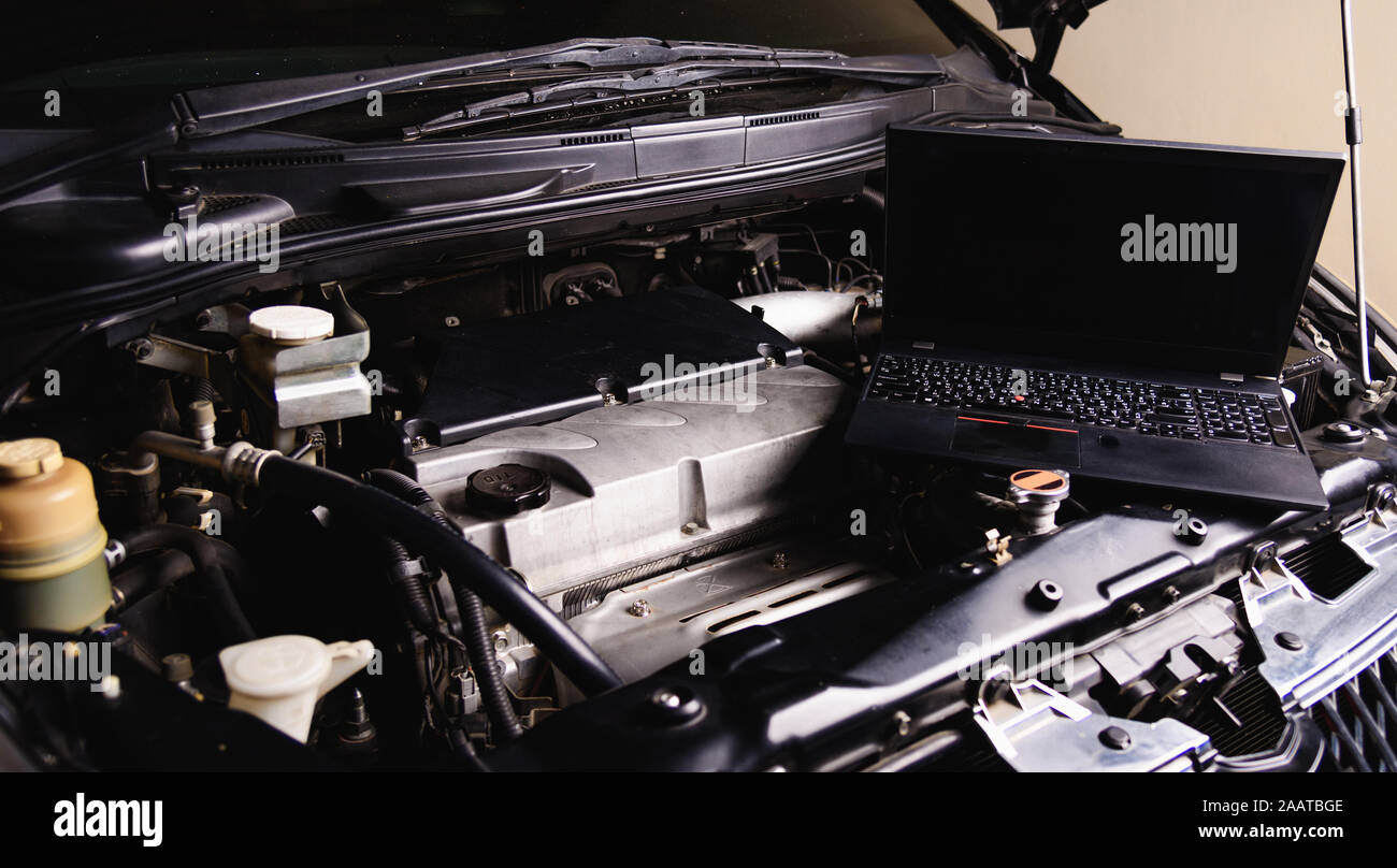 Laptop computer on car mechanic engine for service at workshop Stock ...