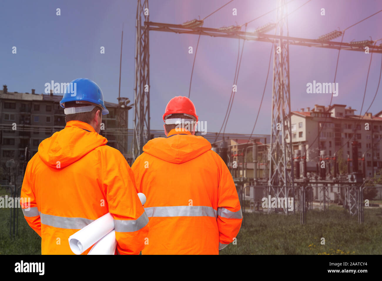Two electrical engineers in substation, back view Stock Photo - Alamy