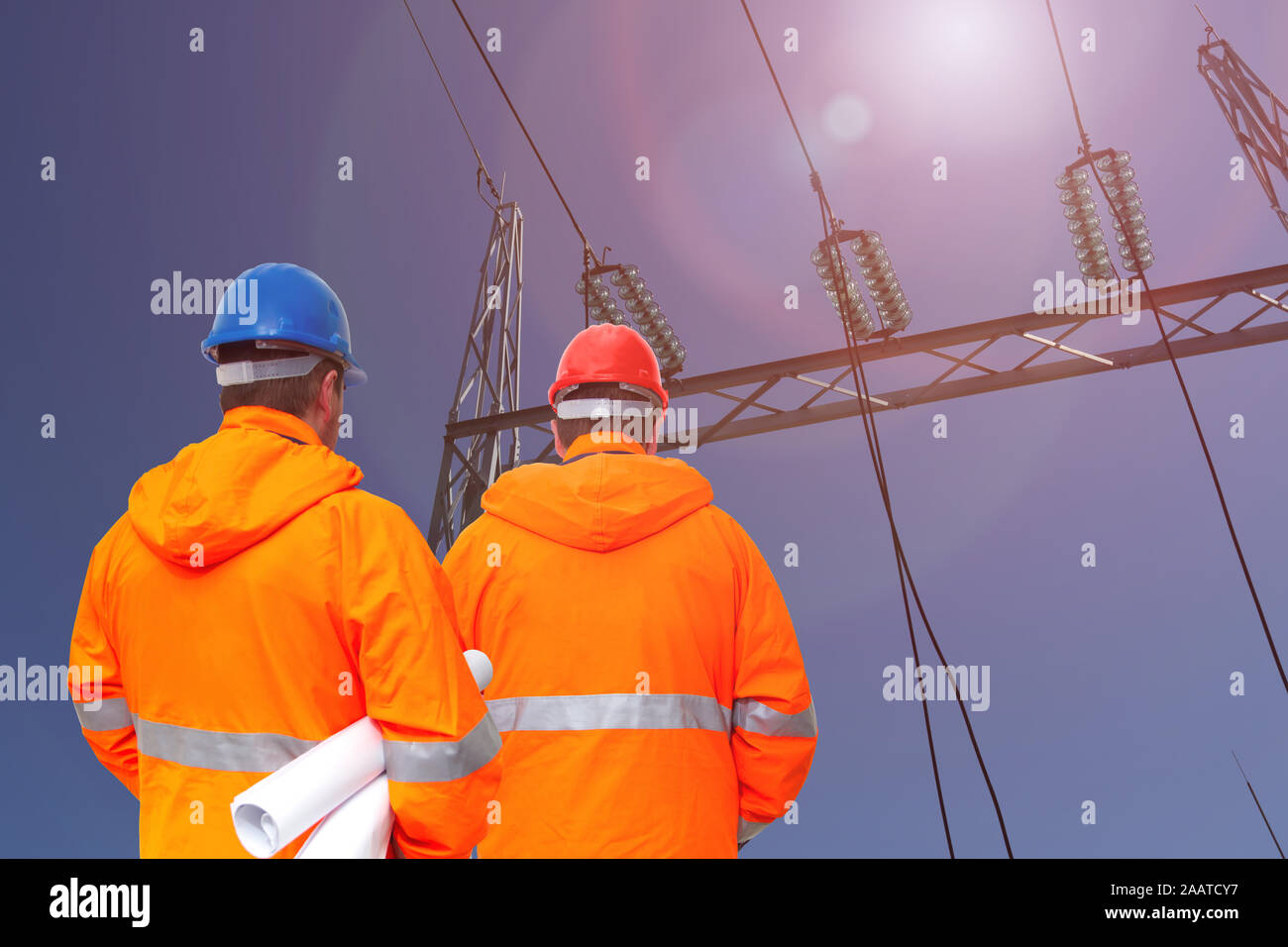 Two electrical engineers in substation, back view Stock Photo - Alamy