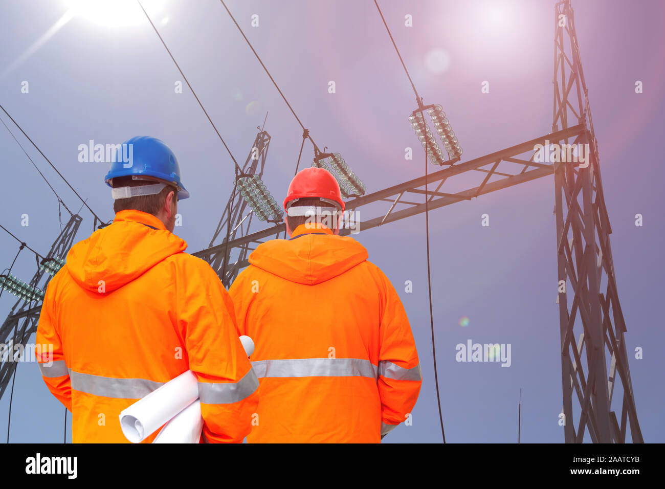 Two electrical engineers in substation, back view Stock Photo - Alamy