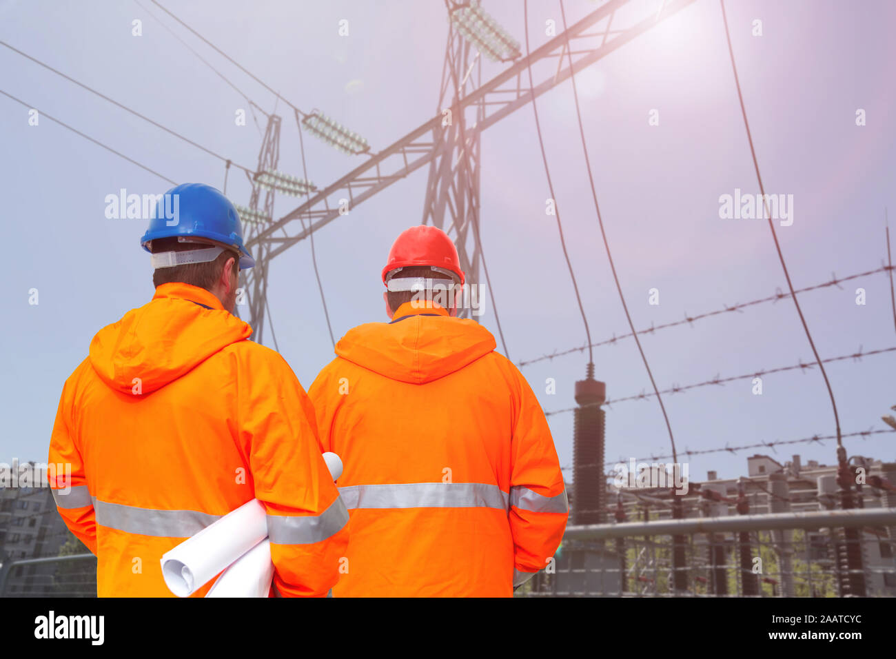 Two electrical engineers in substation, back view Stock Photo - Alamy