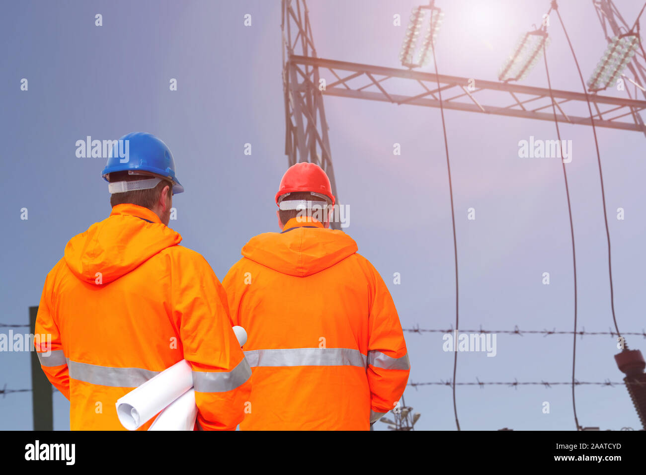 Two electrical engineers in substation, back view Stock Photo - Alamy