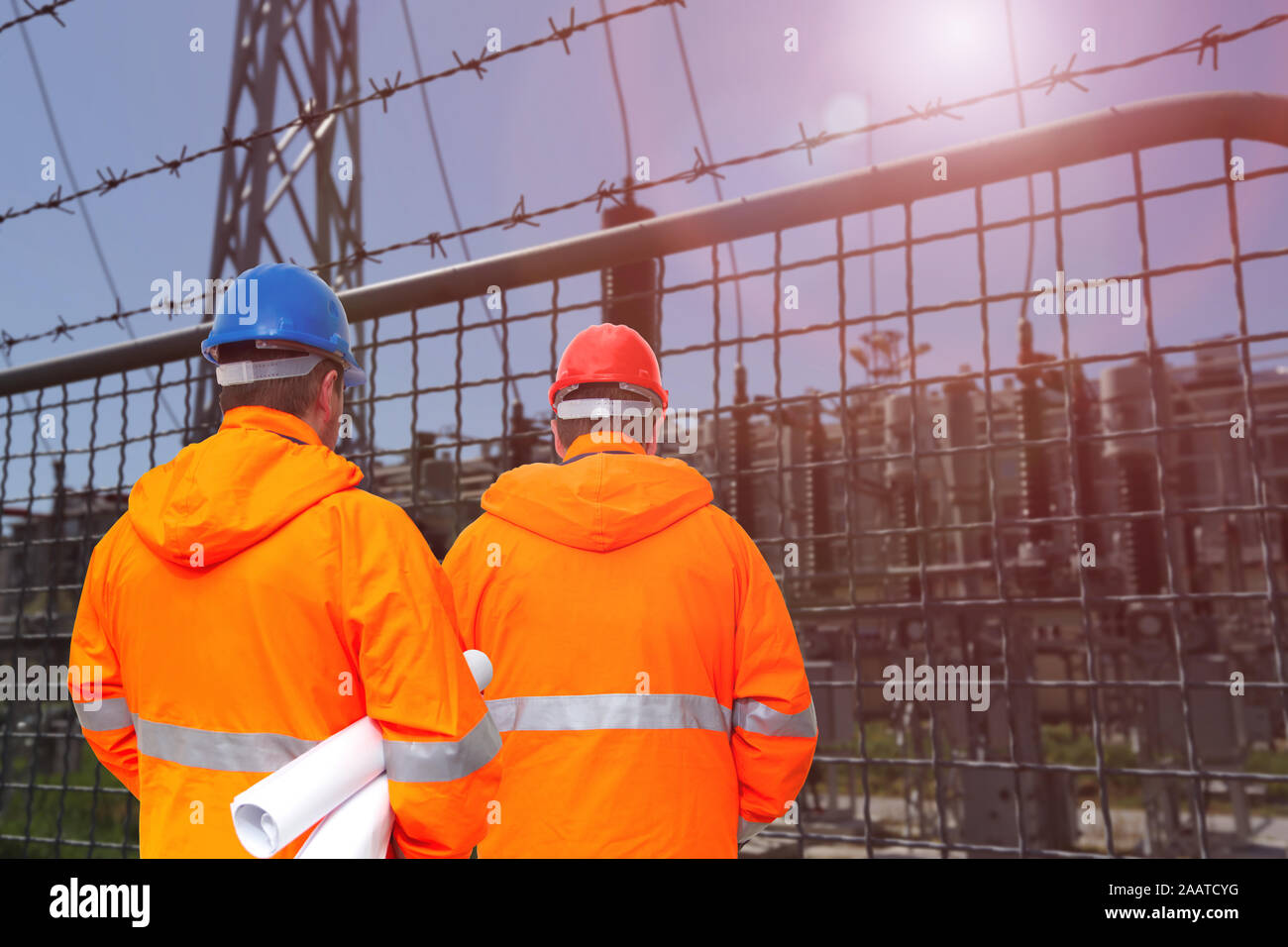 Two electrical engineers in substation, back view Stock Photo - Alamy
