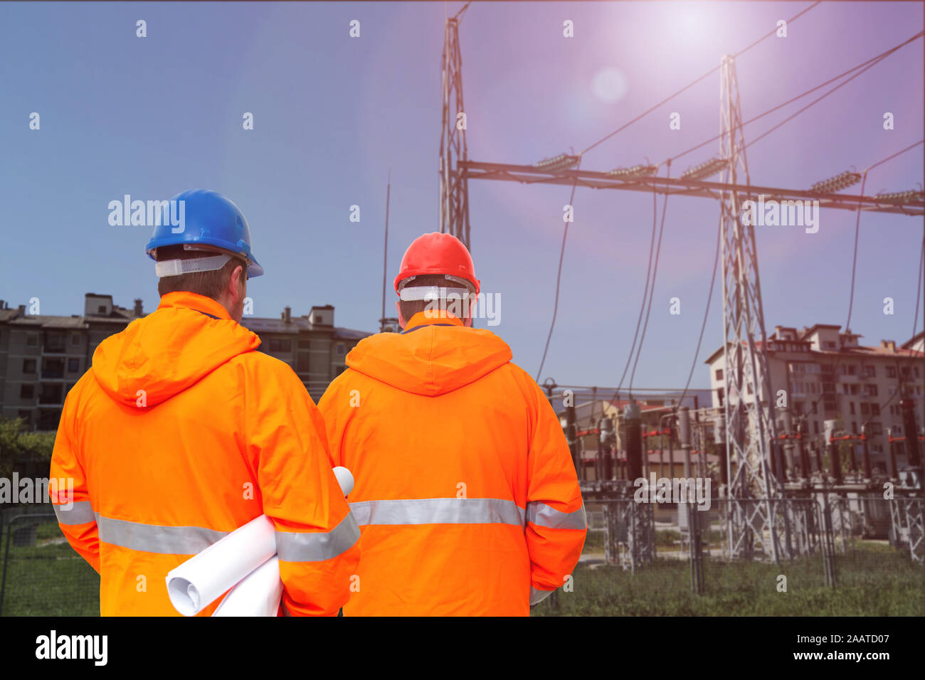 Two electrical engineers in substation, back view Stock Photo - Alamy