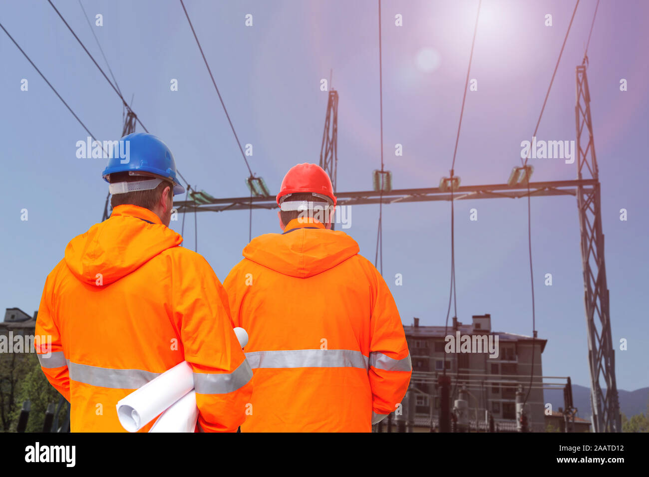 Two electrical engineers in substation, back view Stock Photo - Alamy