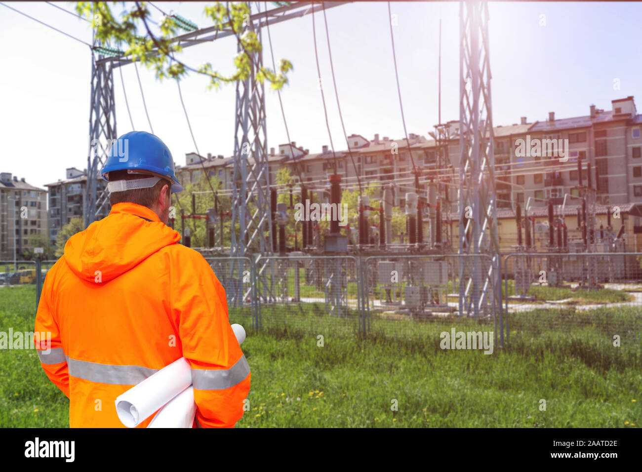 Electrical engineer looking at substation, back view Stock Photo - Alamy