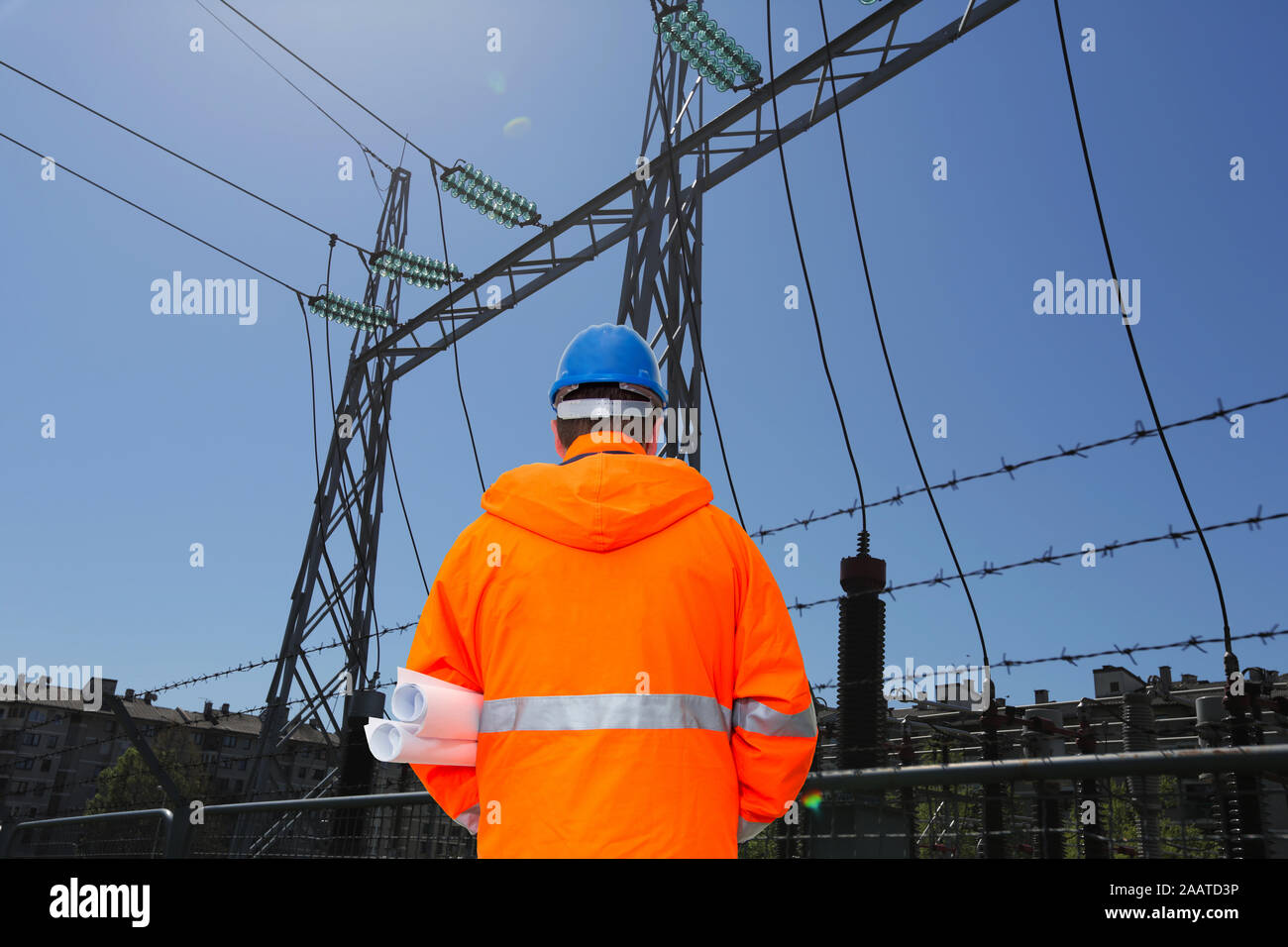 Electrical engineer looking at substation, back view Stock Photo - Alamy