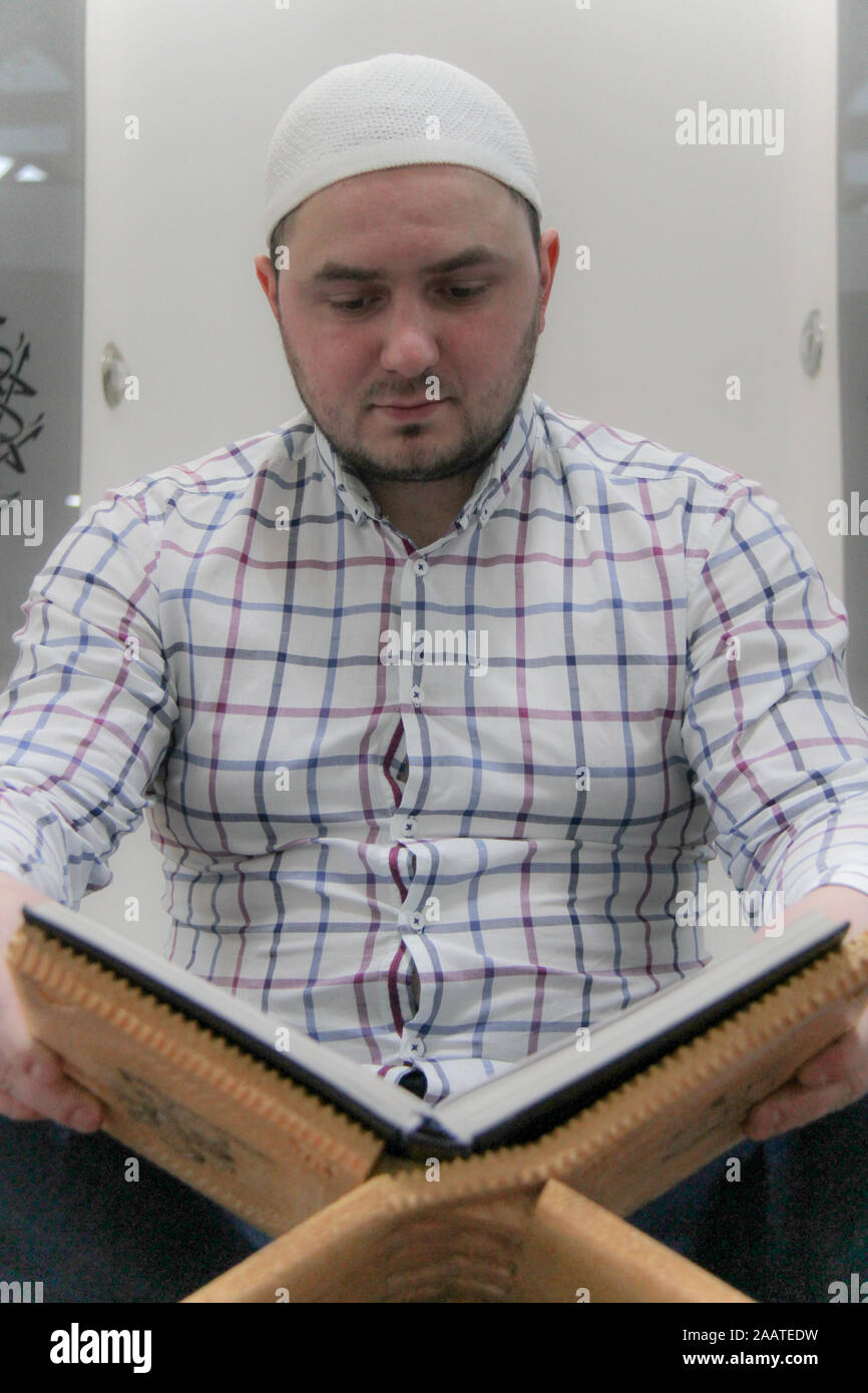 Young muslim man reading the Quran - holy book of Muslims Stock Photo ...