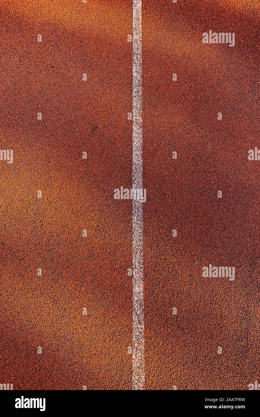 Top view of white line on orange running track with sunlight Stock ...