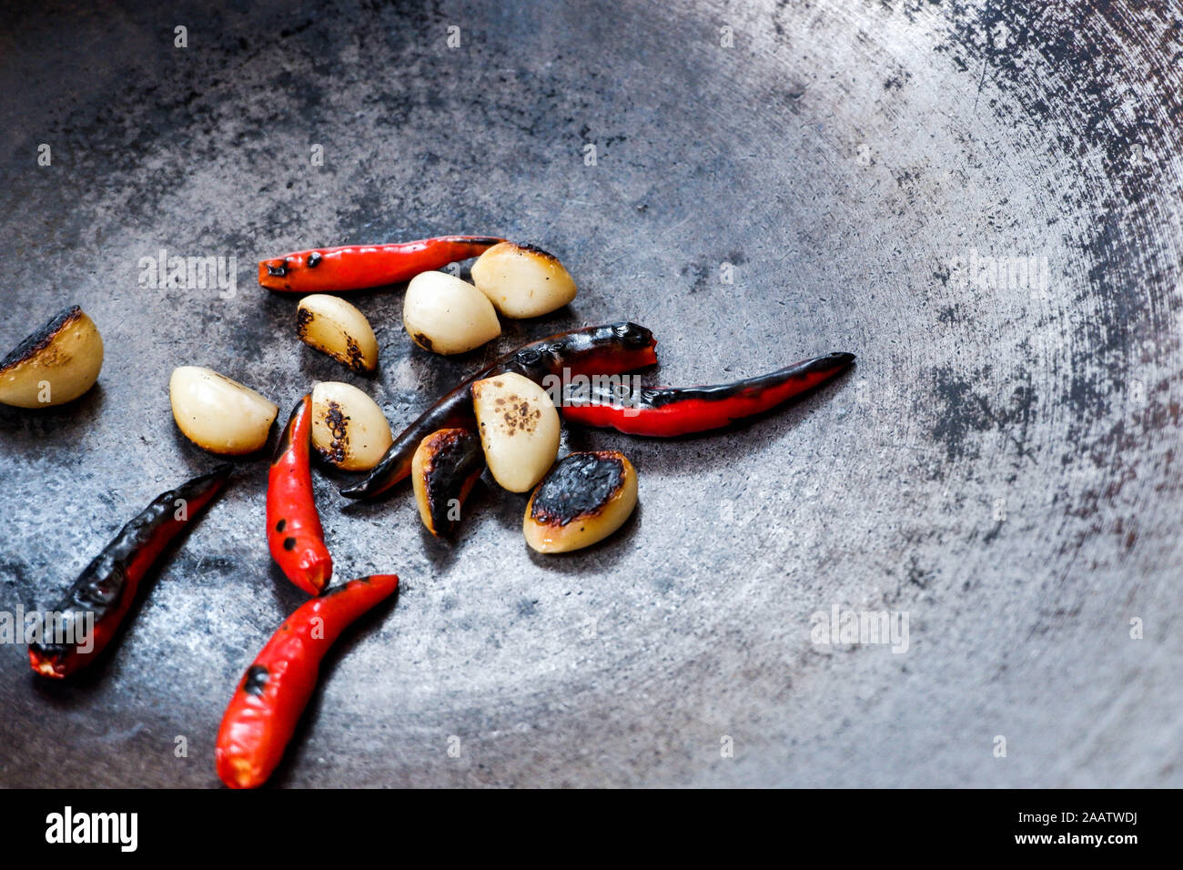 Grilled red chillies in a frying pan for cooking Stock Photo - Alamy