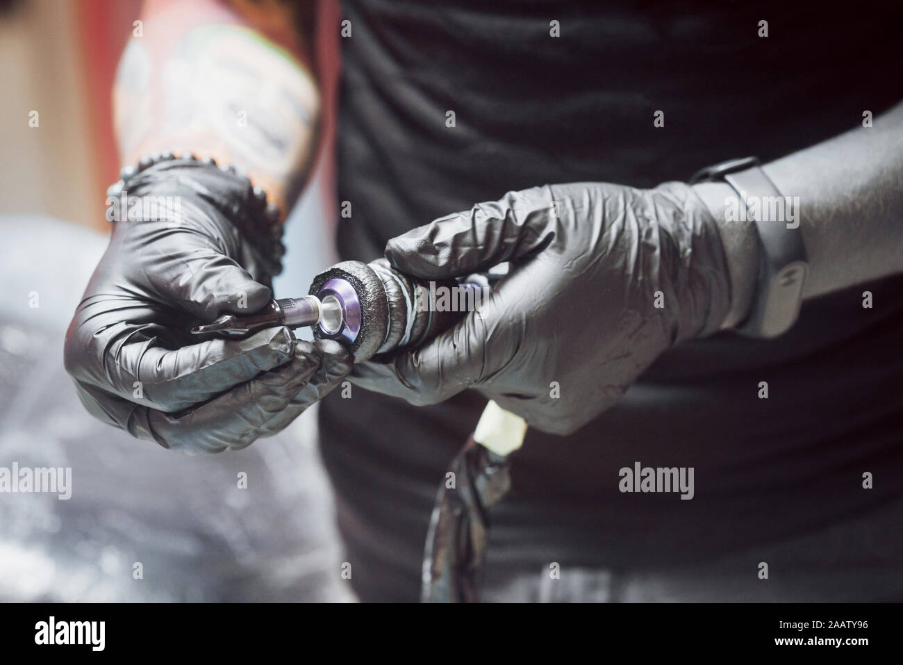 Artist holding tattoo machine in his studio, he is ready to accept the ...