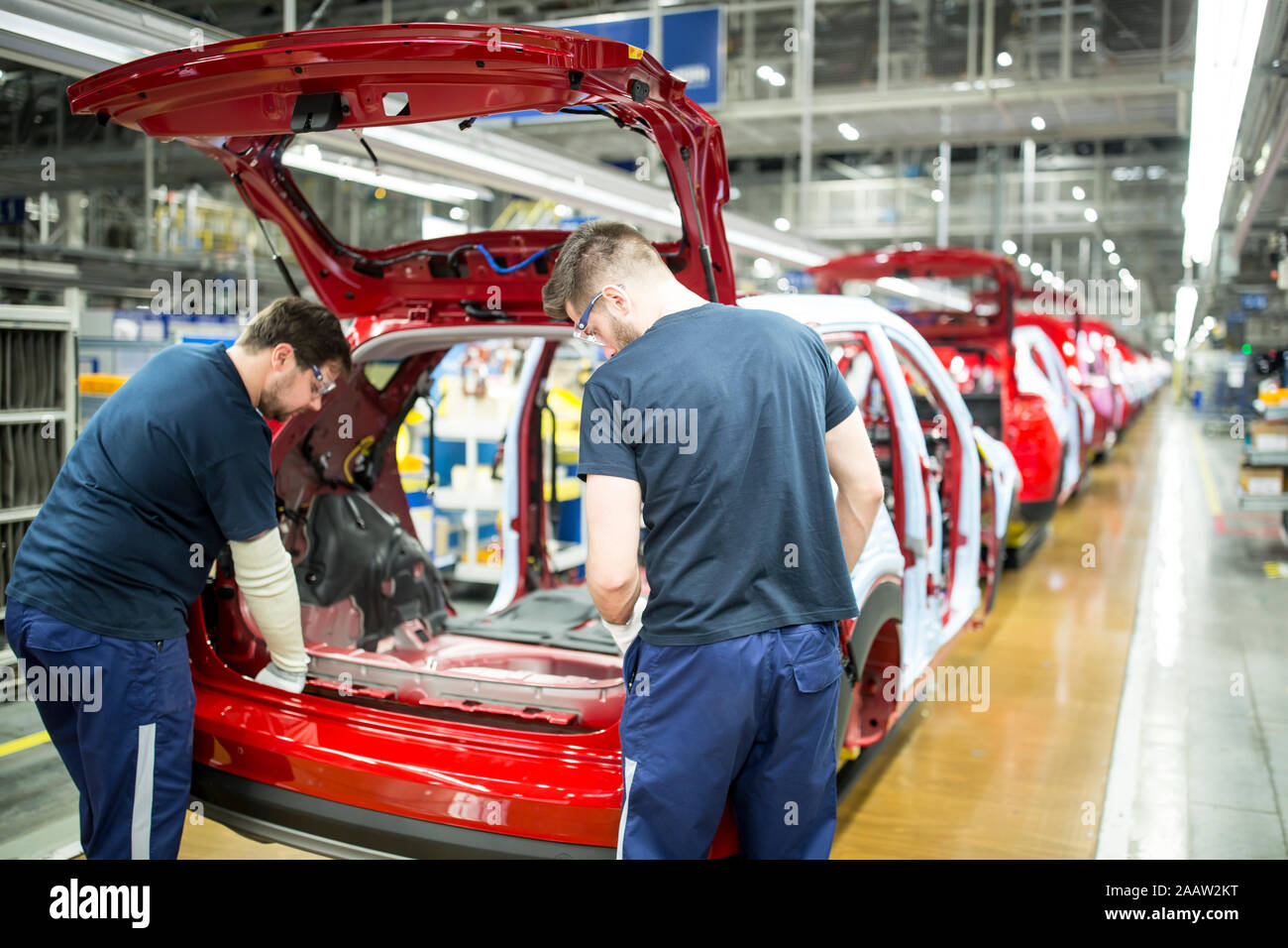 Two colleagues working in modern car factory Stock Photo - Alamy