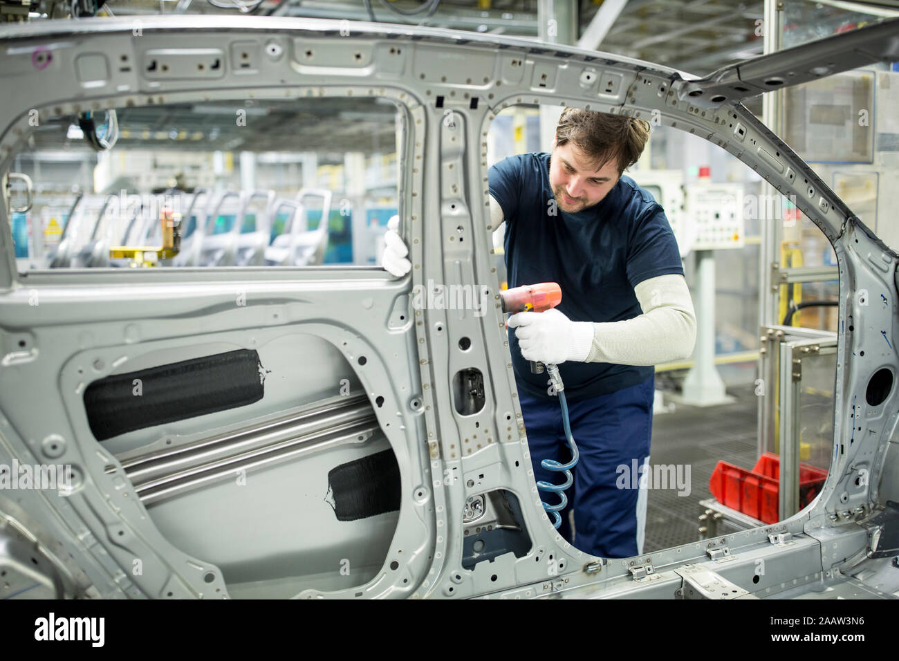 Car factory worker assembling door hi-res stock photography and images ...