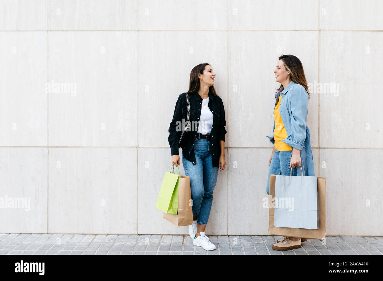 Two friends talking during shopping Stock Photo - Alamy