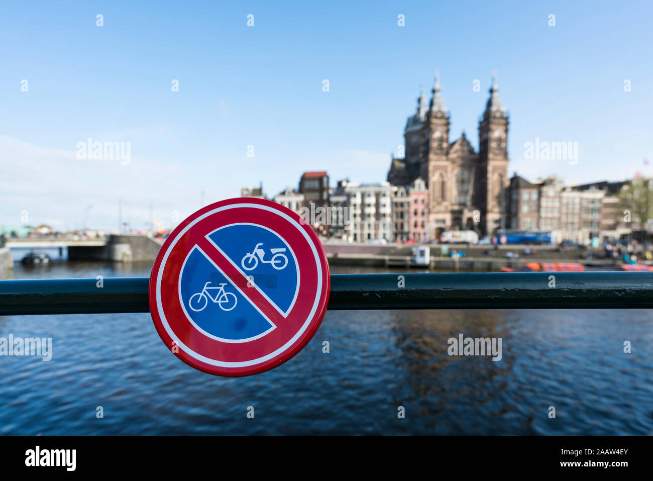 Netherlands, Amsterdam, No cycling sign hanging on railing with ...