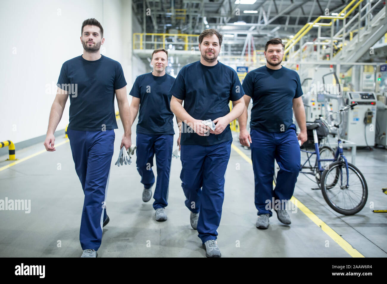 Colleagues having a break and walking in a modern factory Stock Photo ...