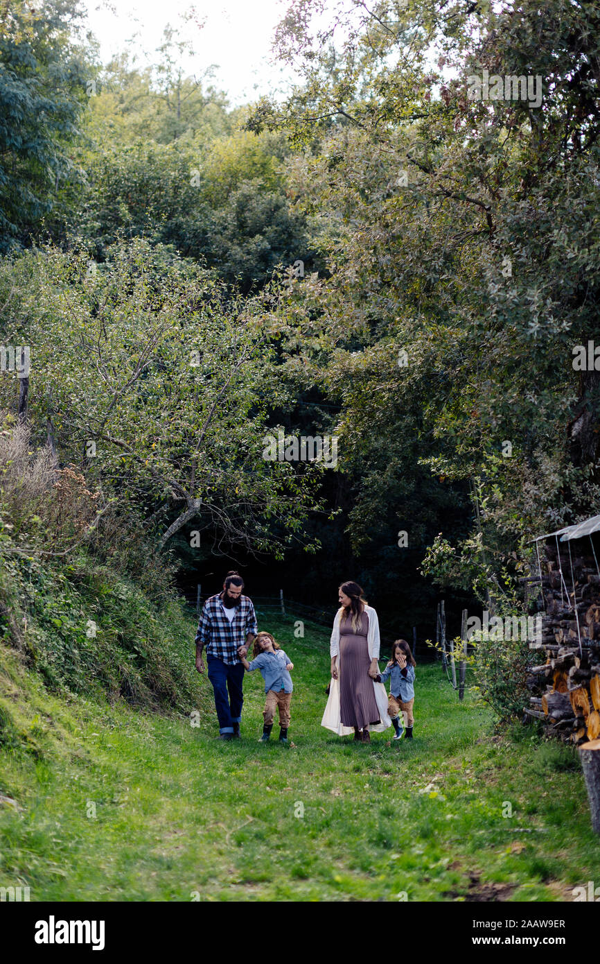Family with two kids walking in the countryside Stock Photo - Alamy