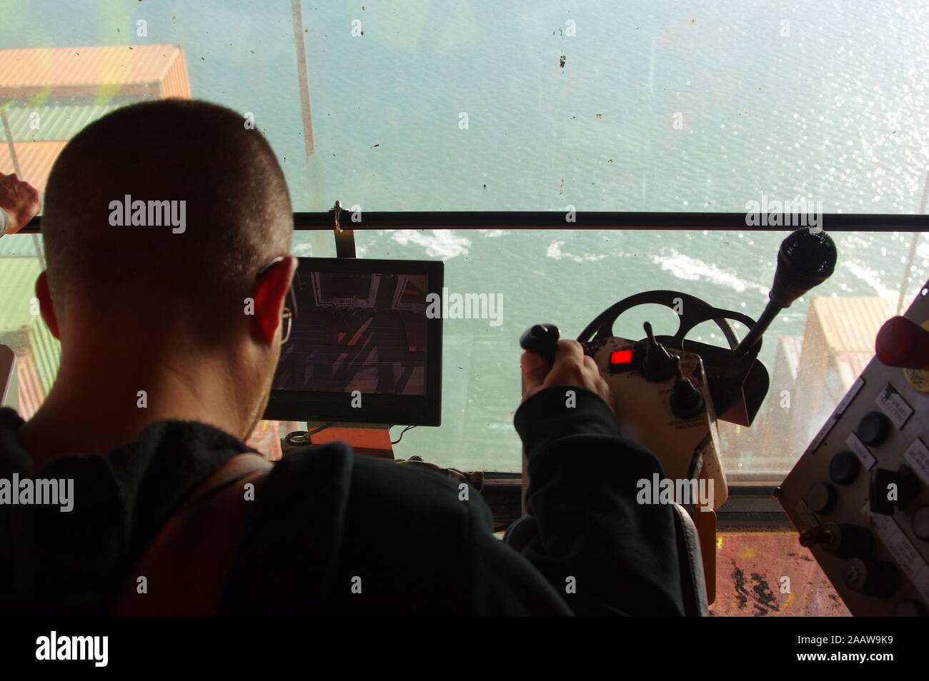 Gantry crane operator moving a sea container in the Port Stock Photo ...