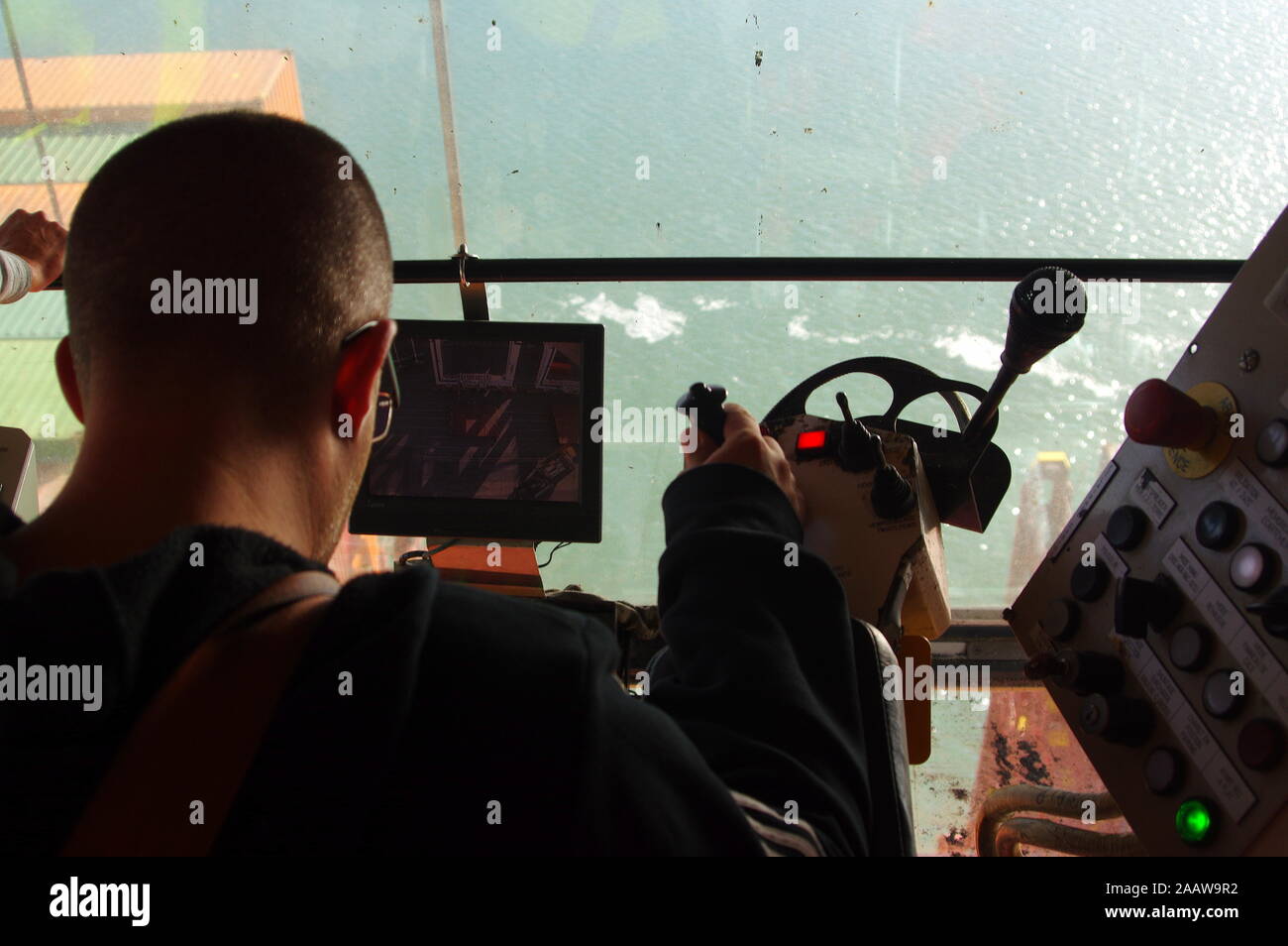 Gantry crane operator moving a sea container in the Port Stock Photo ...