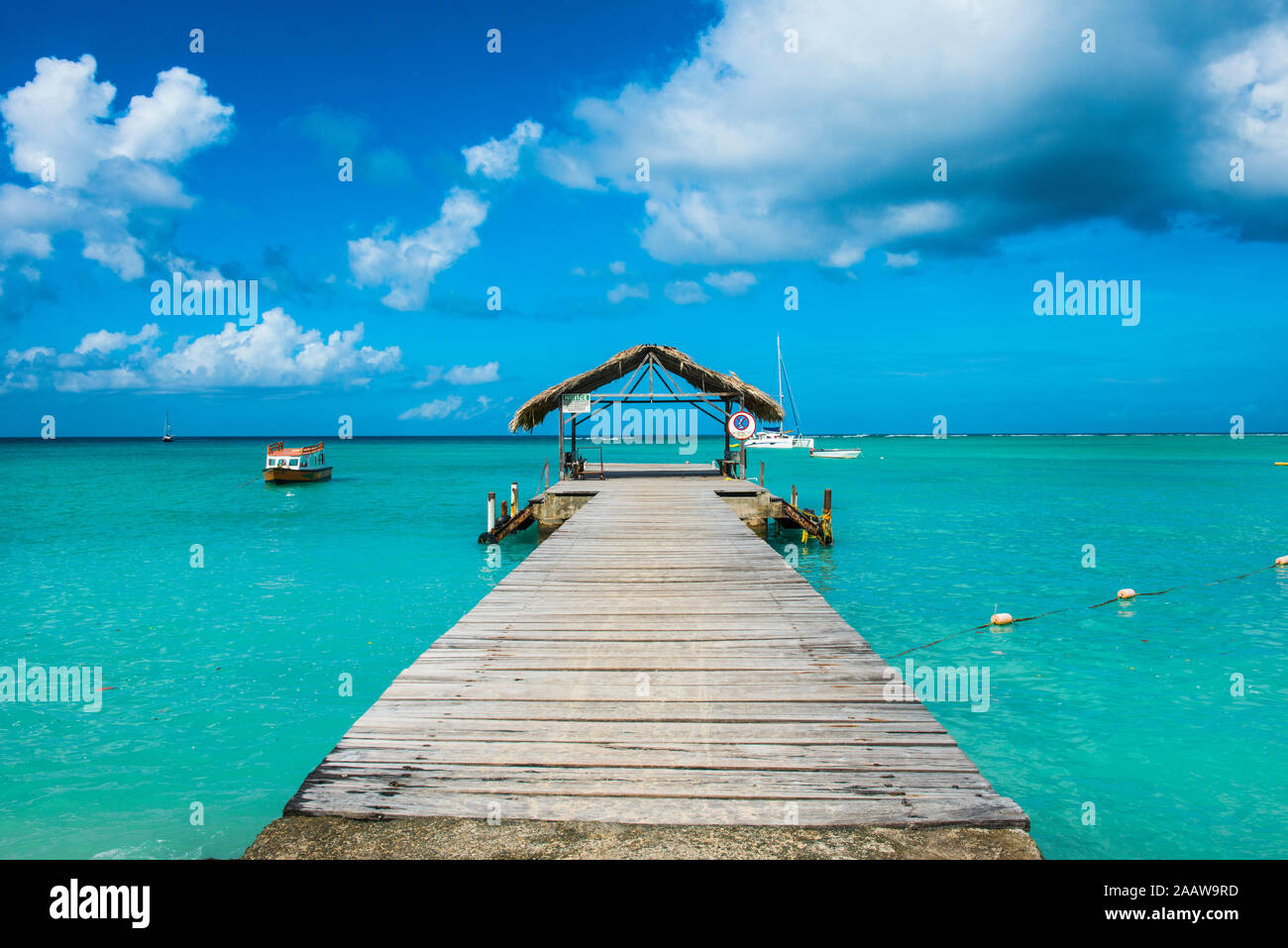 Diminishing perspective of pier over Caribbean sea at Pigeon Point ...