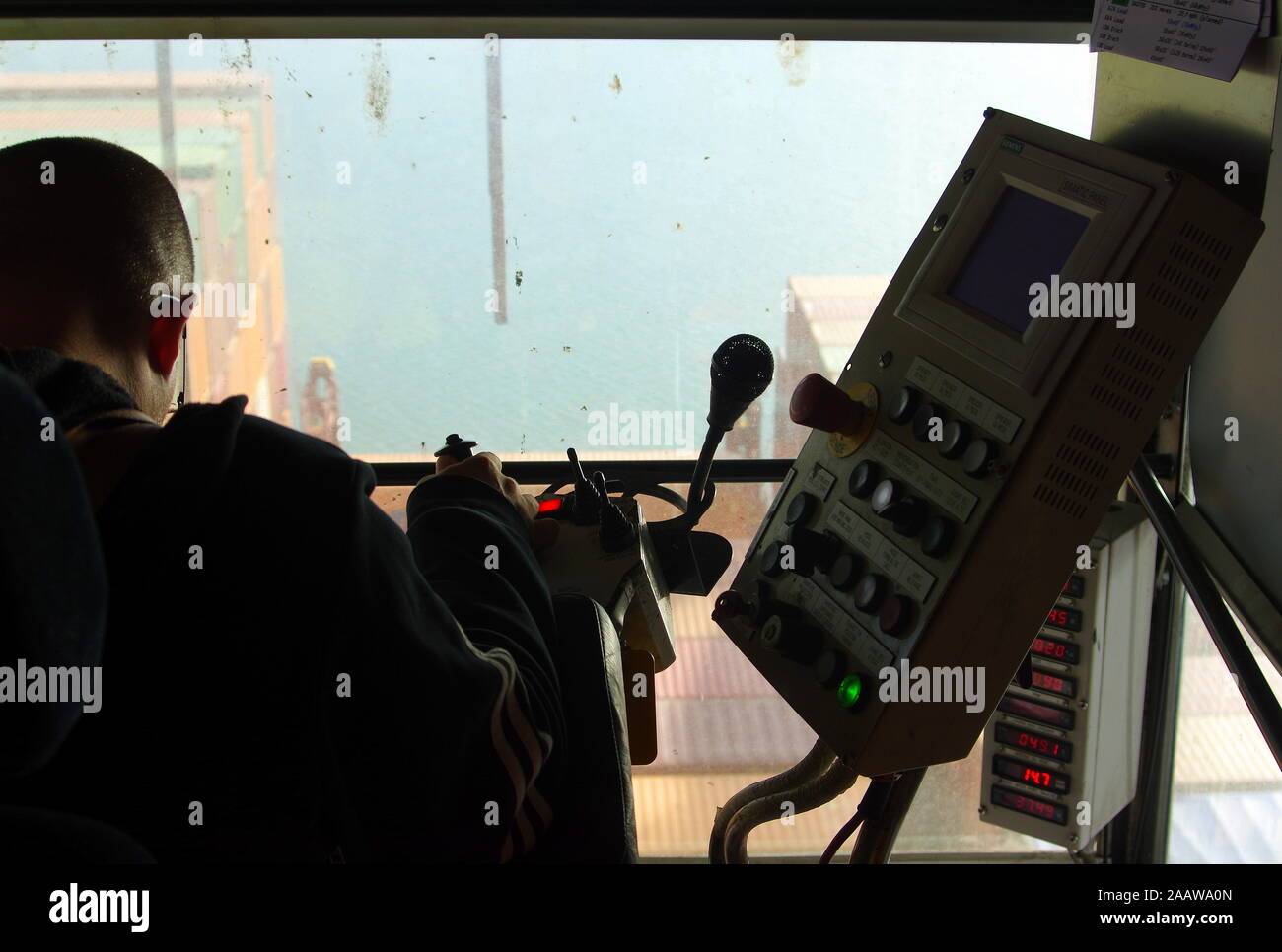 Gantry crane operator moving a sea container in the Port Stock Photo ...
