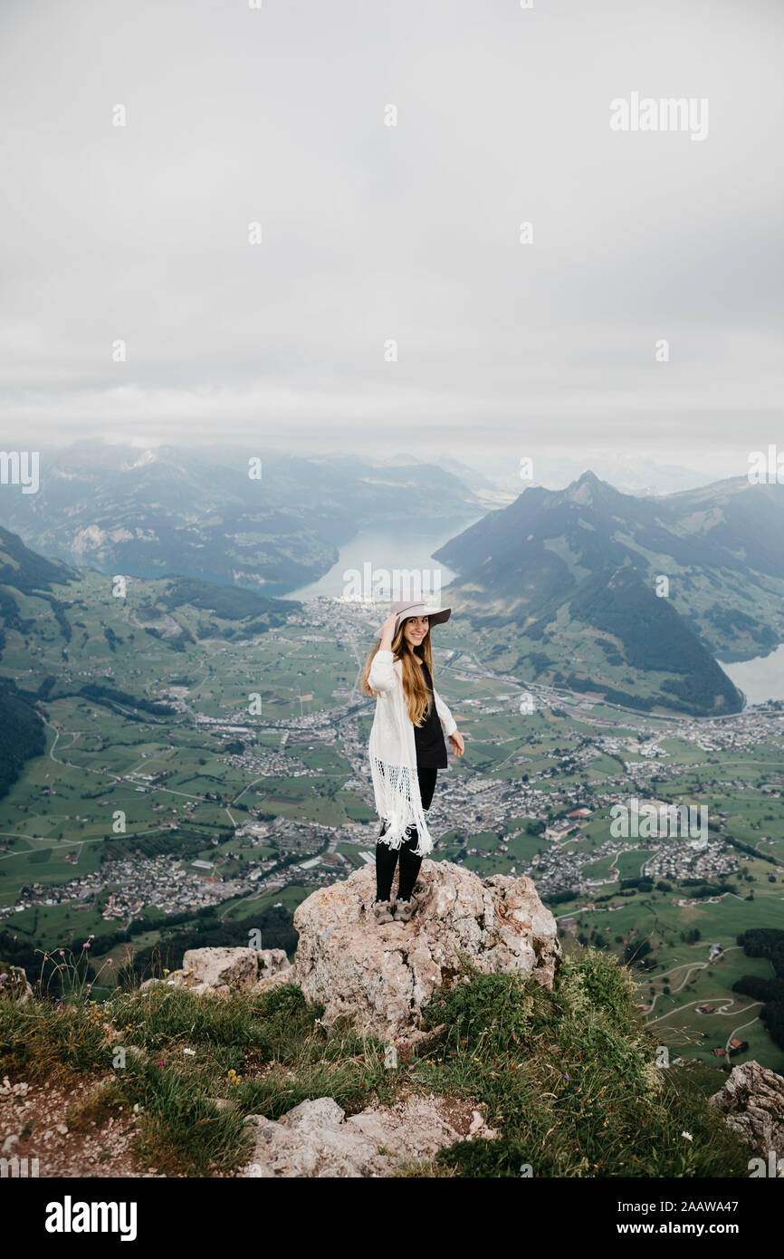 Young woman wearing hat, standing on viewpoint, Grosser Mythen ...
