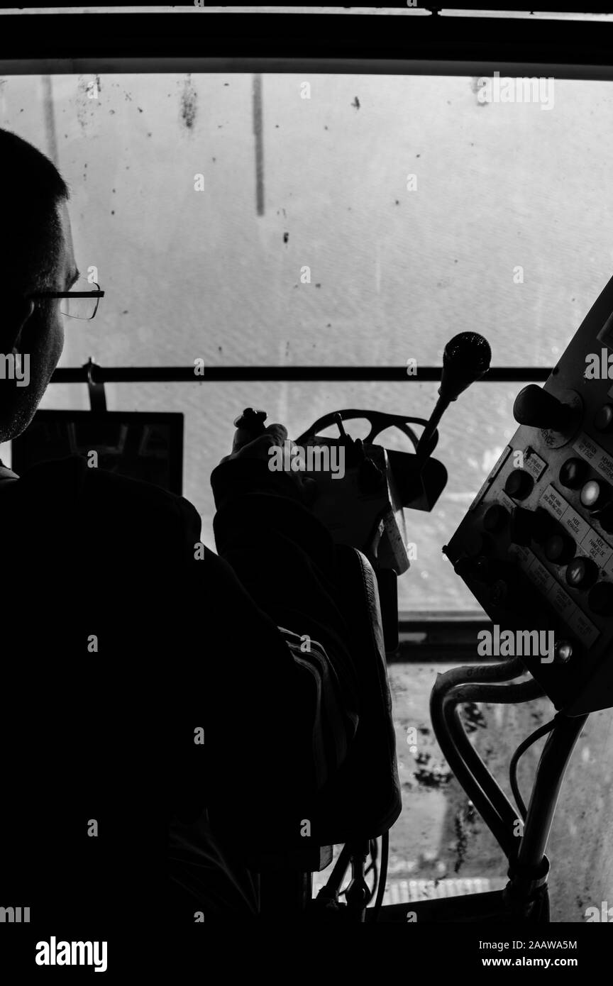Gantry crane operator moving a sea container in the Port Stock Photo ...