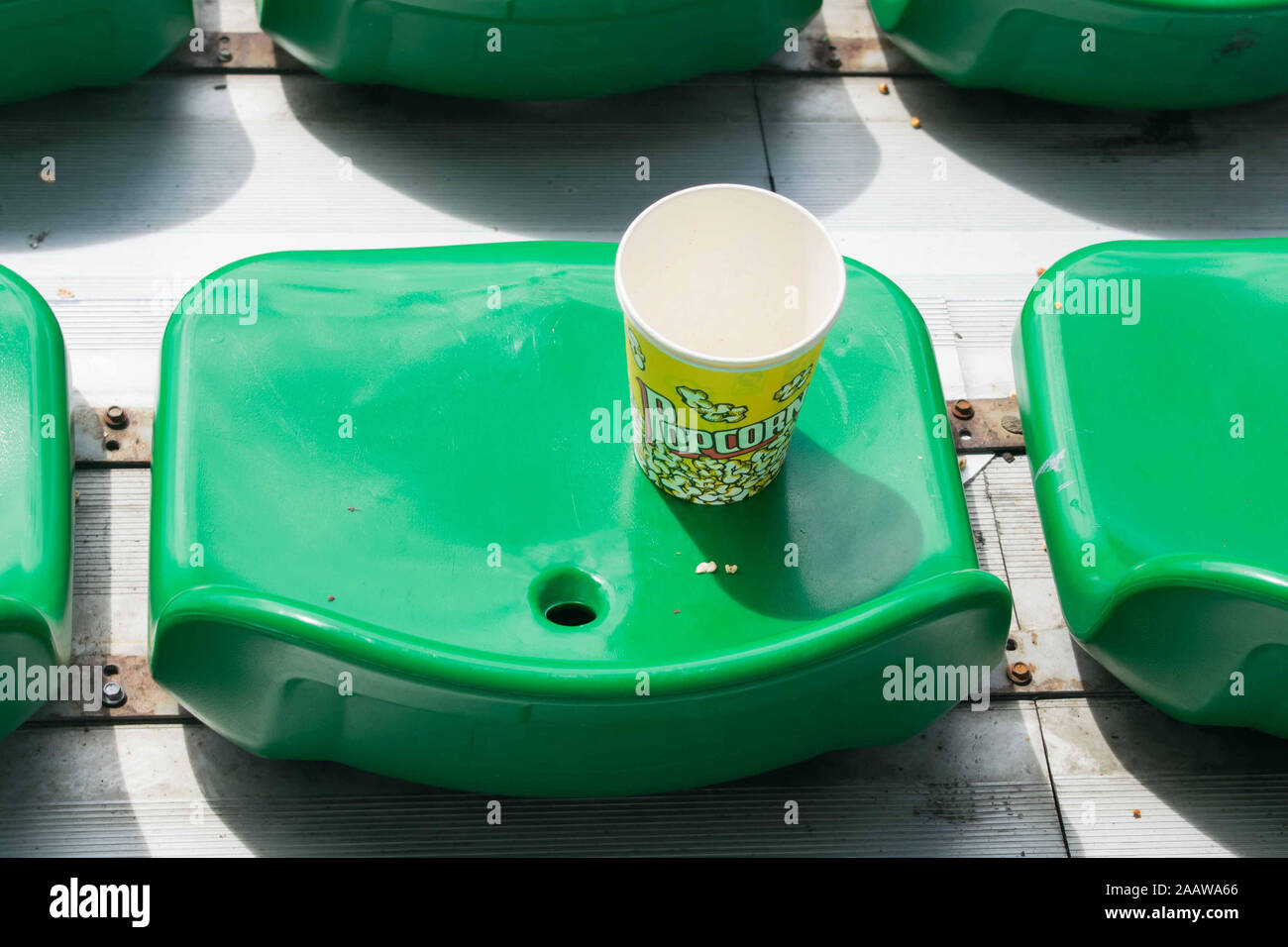 Green plastic bench with a paper cup sitting on the stool Stock Photo ...