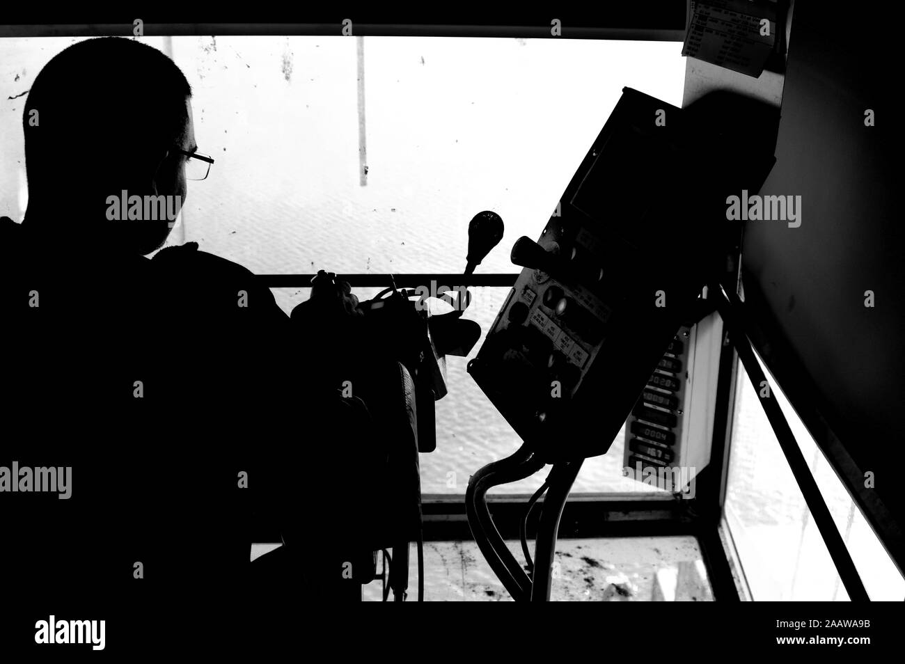 Gantry crane operator moving a sea container in the Port Stock Photo ...