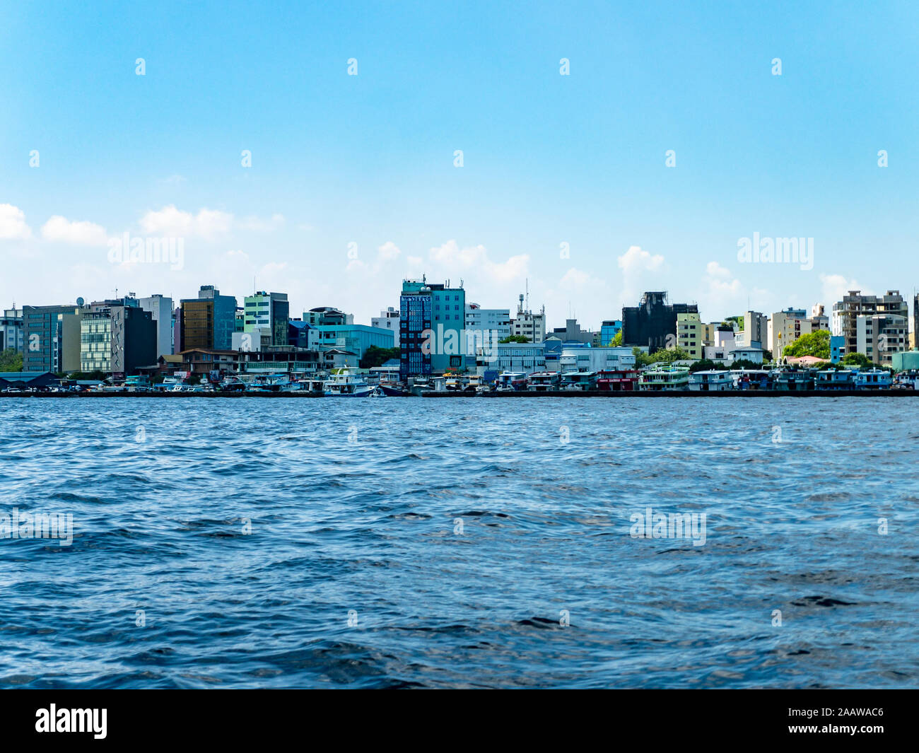 Buildings by North Malé Atoll against blue sky, Maldives Stock Photo ...